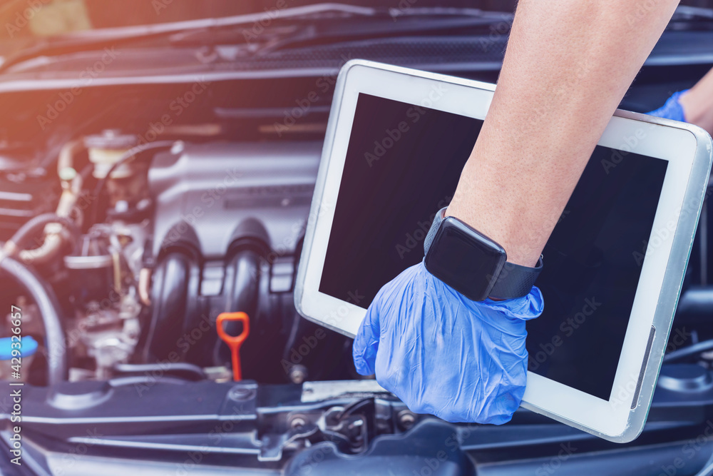 Automobile mechanic repairman hands repairing a car engine automotive ...