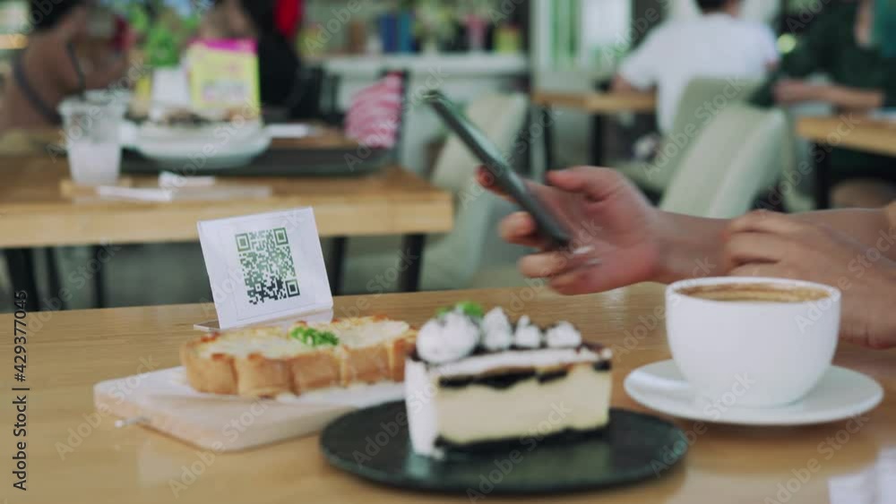 woman scanning the QR code to order food and pay money. Restaurants ...