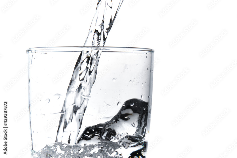 Glass of water being filled. Close up pouring clear water in ...