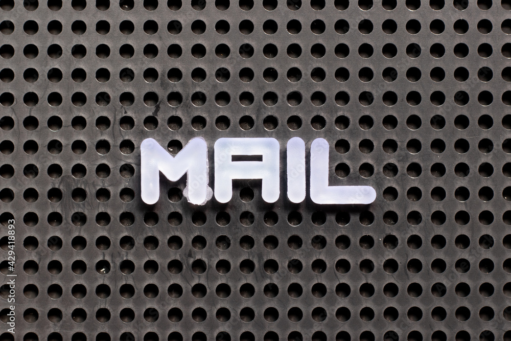 White color letter in word mail on black pegboard background Stock ...