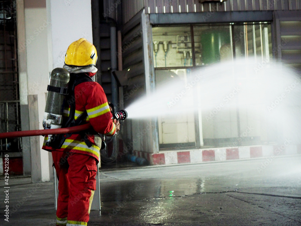 firefighter training., fireman using water and extinguisher to fighting ...