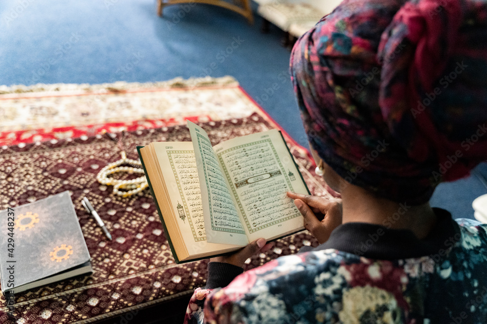 Black Muslim woman studying and reading Stock Photo | Adobe Stock