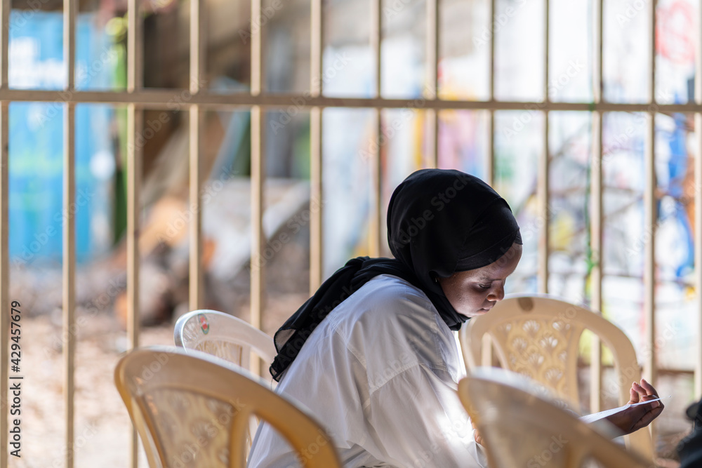 Black Muslim Woman writing Stock Photo | Adobe Stock