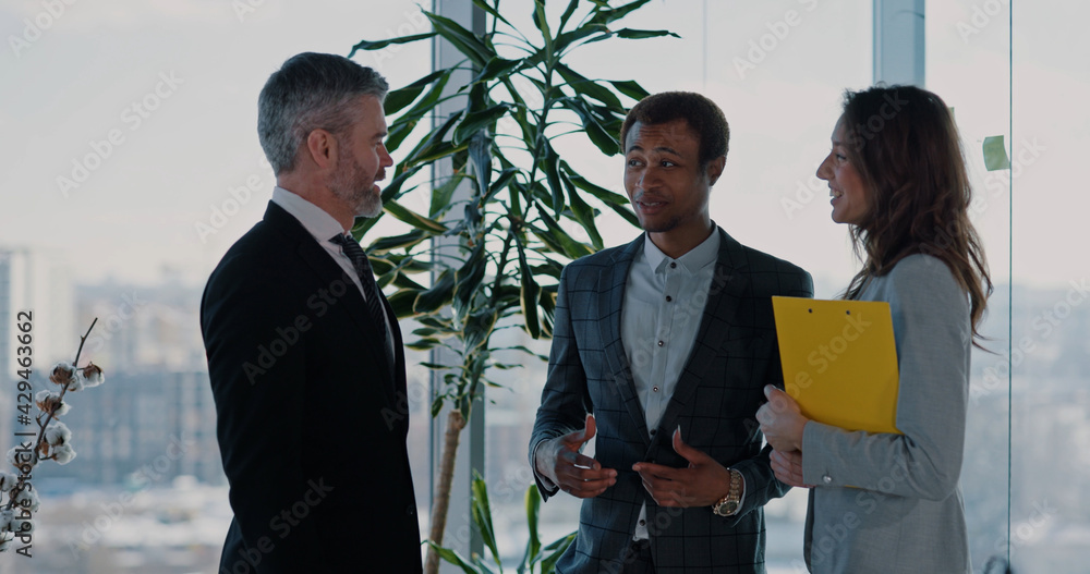 Corporate three people partners shaking hands on agreement welcoming ...