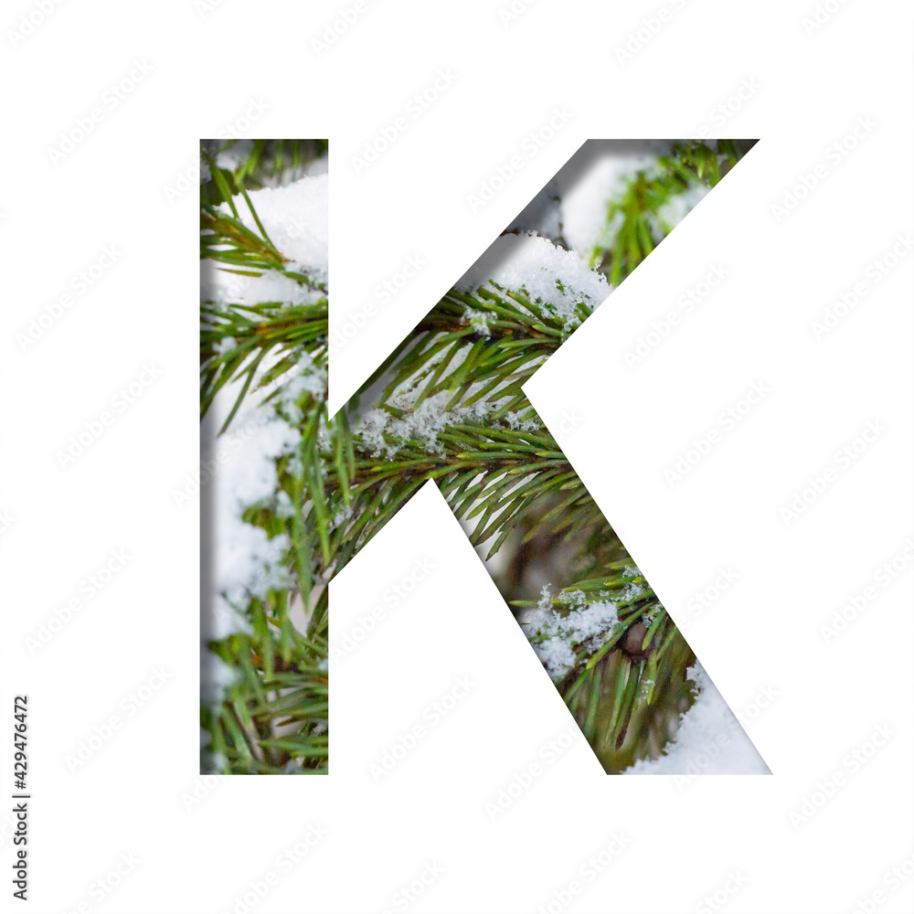 Winter font. Letter K, cut out of paper against the background of ...
