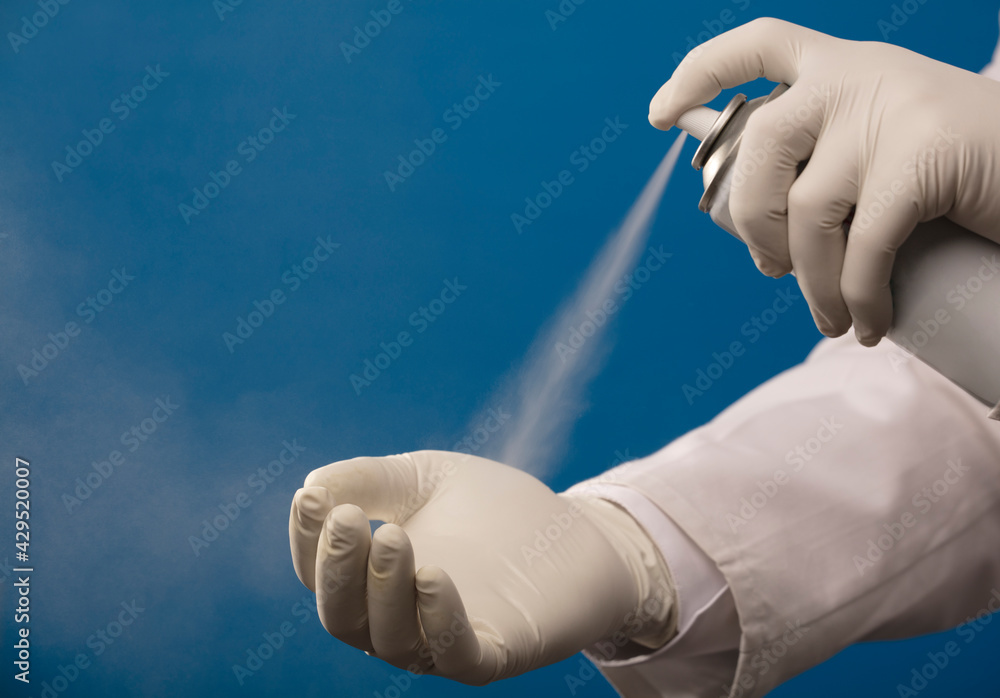 doctor clean hands with spray, hygiene in hospital, PPE standards, blue ...