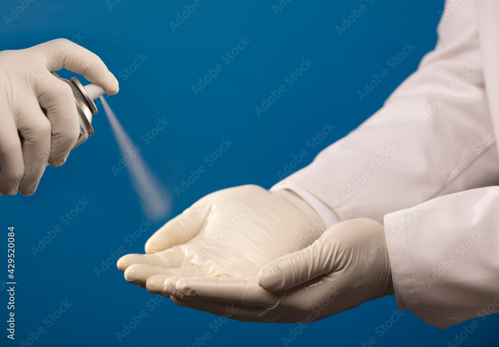 doctor clean hands with spray, hygiene in hospital, PPE standards, blue ...