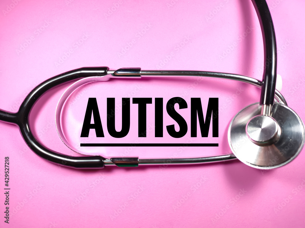 Word AUTISM on pink background with stethoscope.Medical concept. Stock ...