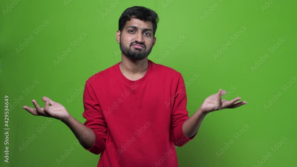 Indian man with distrust face expression. Doubtful young man looking ...