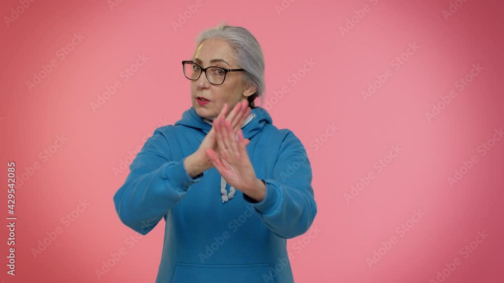 Elderly granny gray-haired woman say no hold palm folded crossed hands ...