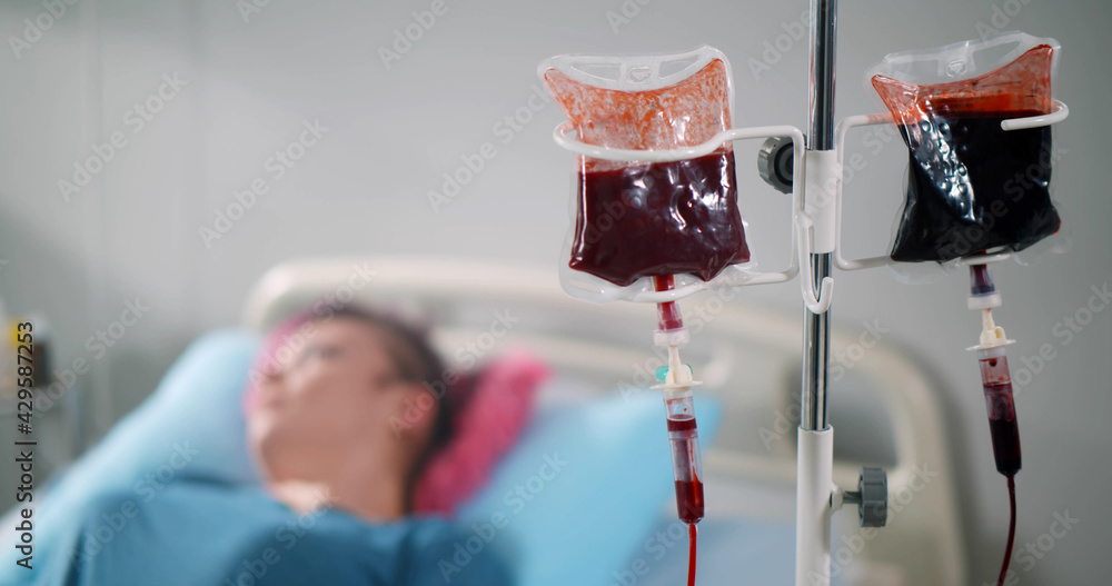 Blood transfusion to young woman patient in hospital bed Stock Photo ...