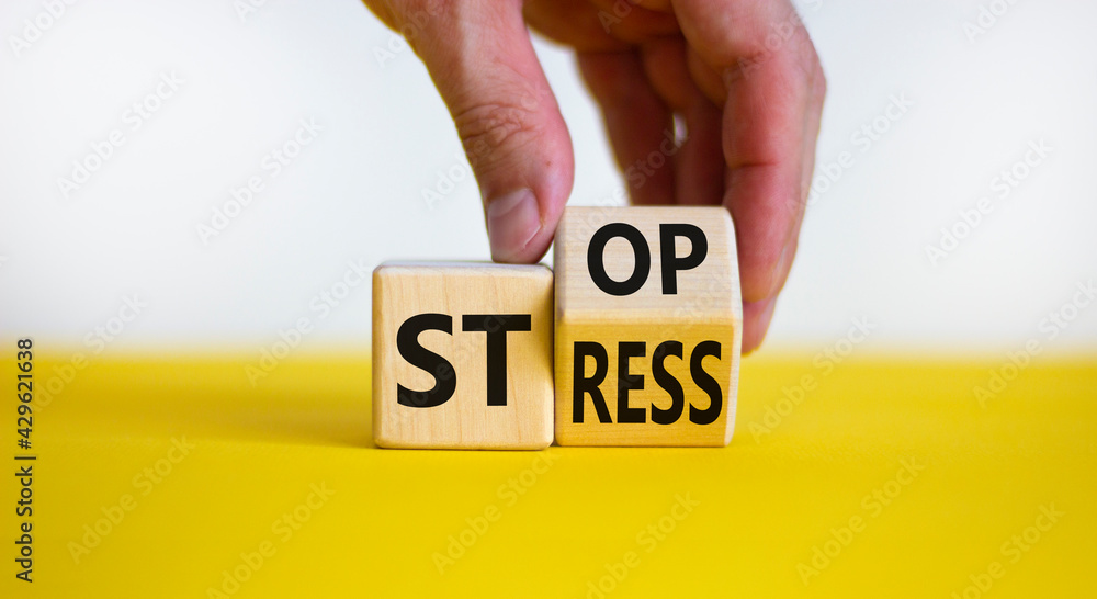 Stop stress and be health symbol. Doctor turns a cube and changes words ...