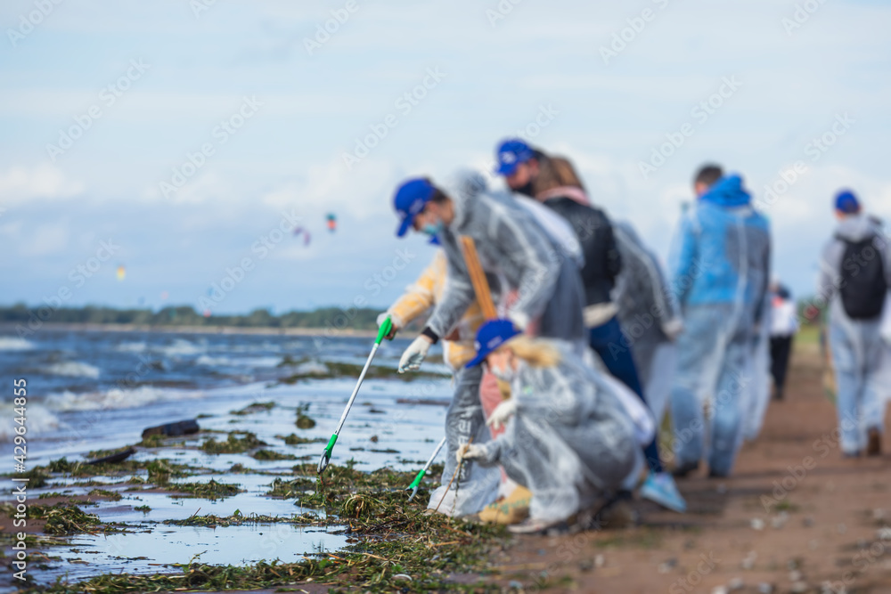 Process of cleaning up the shore beach line from litter garbage rubbish ...