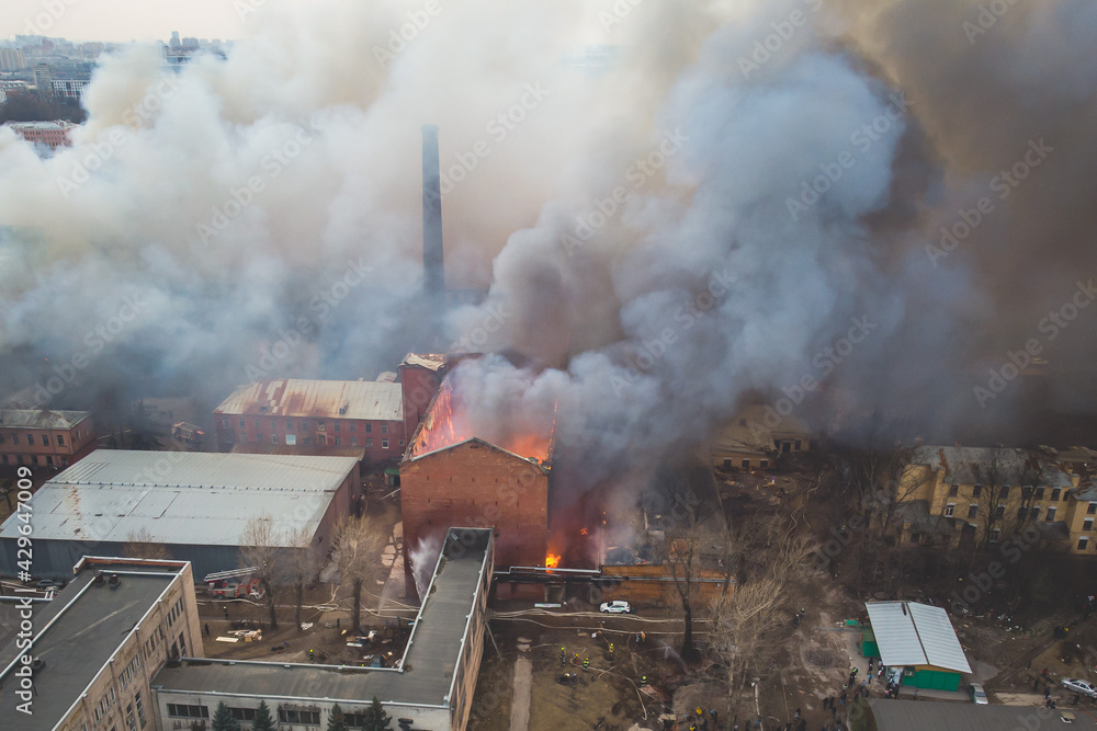 Massive large blaze fire in the city, aerial drone top view brick ...