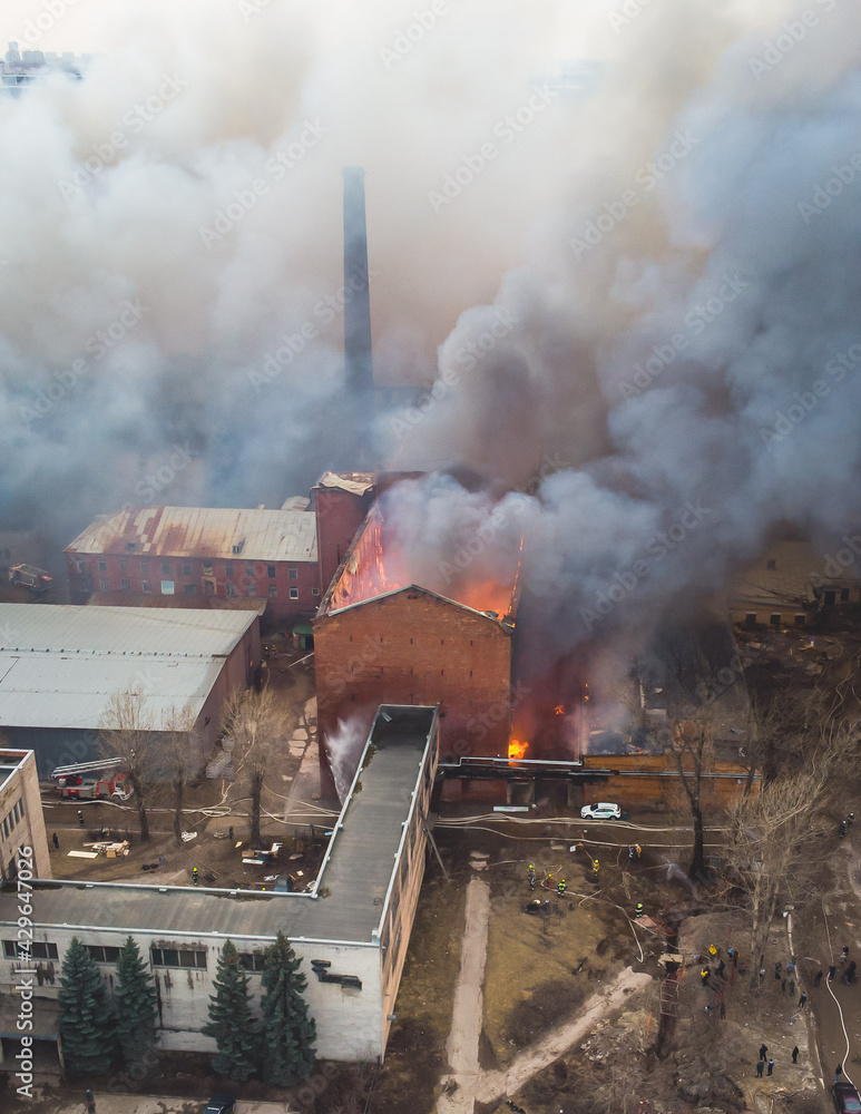 Massive large blaze fire in the city, aerial drone top view brick ...