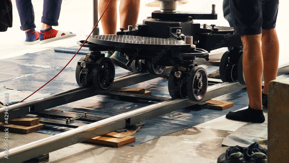 Dolly. Film production Dolly track. Production crew team setting dolly ...