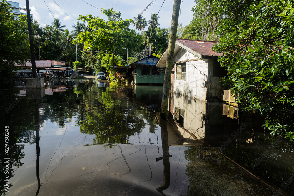 Houses flooded due to high tide and sea level rise in Palau Stock Photo ...