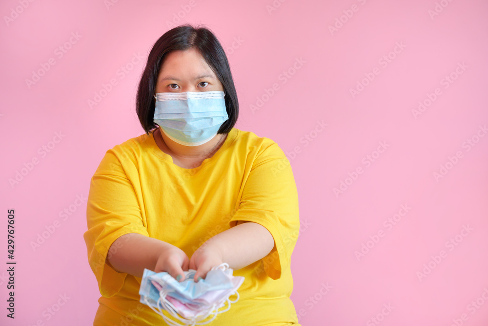 Image of a young woman with Down syndrome Wear a mask to protect ...