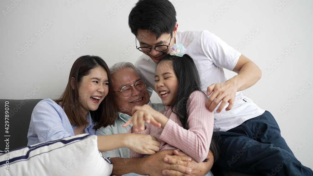 Asian family enjoying happily together on sofa in weekend. Large family ...