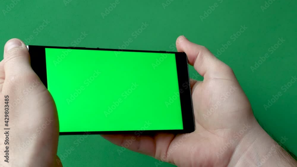 Touch screen to press a finger on a green screen in a smartphone, a ...