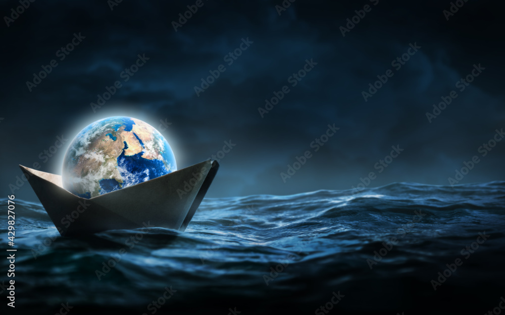 Planet earth in a paper boat floating in the ocean. Faith or religion ...