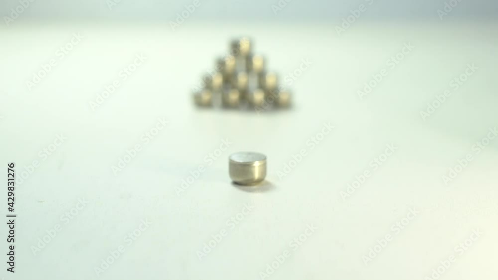 Close up on button battery. The batteries are stacked into a triangle ...