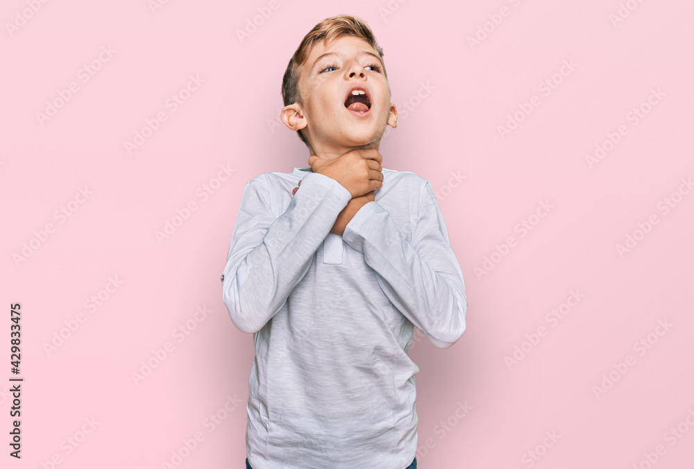 Little caucasian boy kid wearing casual clothes shouting and suffocate ...