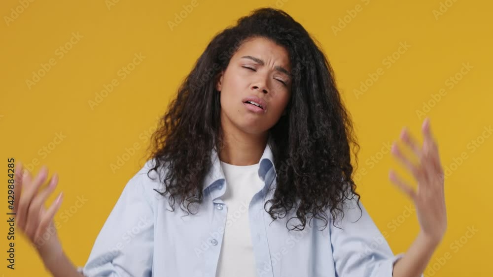 Sad upset fan young african woman curly hair 20s years old wears blue ...
