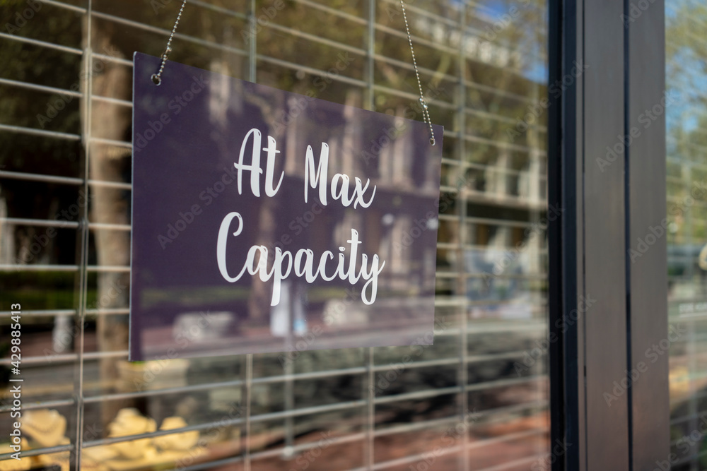 At Max Capacity sign at the entrance to a retail store when maximum ...