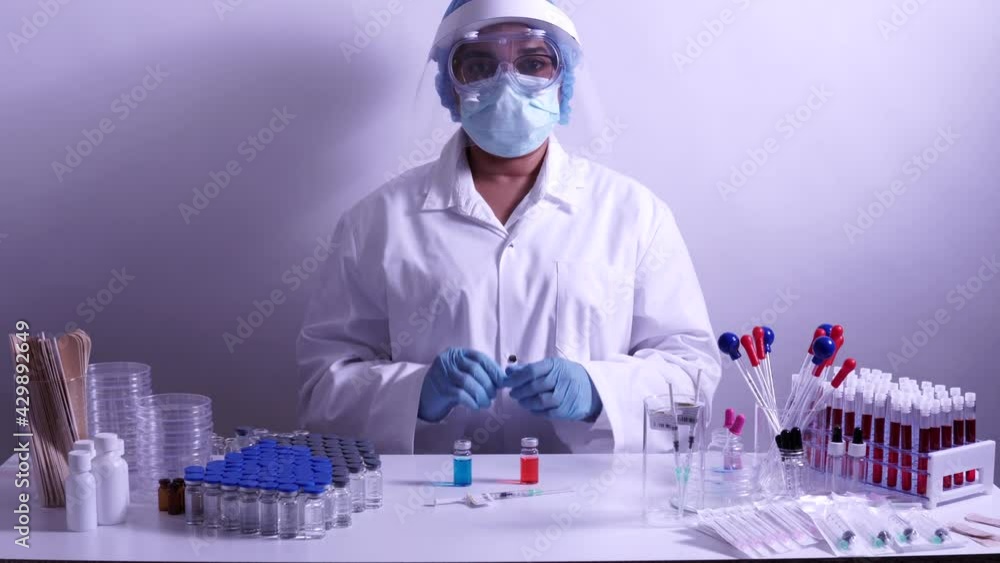 Medical Nurse in safety gloves and protective mask is showing different ...