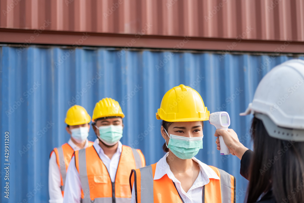Selective focus at face of female industrial warehouse container worker ...
