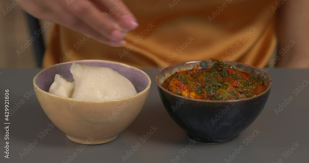 Two bowls on table with West African traditional dishes. Unrecognizable ...