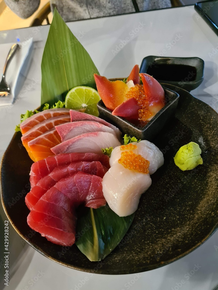 Fresh sashimi platter with kingfish, seared tuna, salmon and scallop at ...