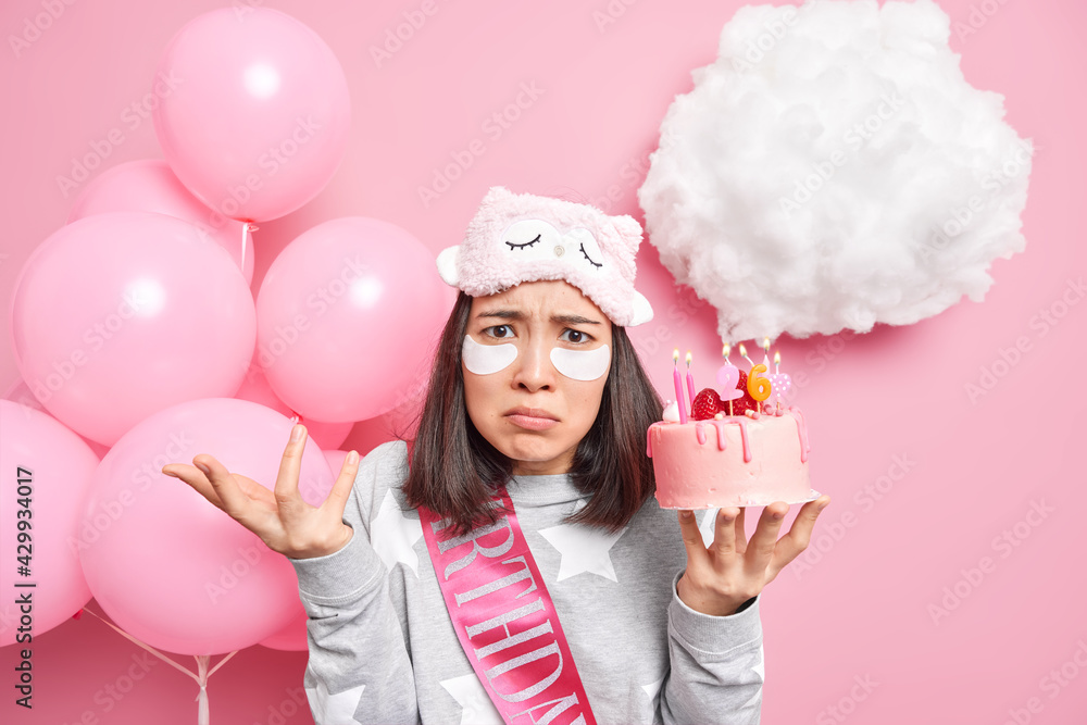Puzzled Asian woman looks with dissatisfied frustrated expression asks ...