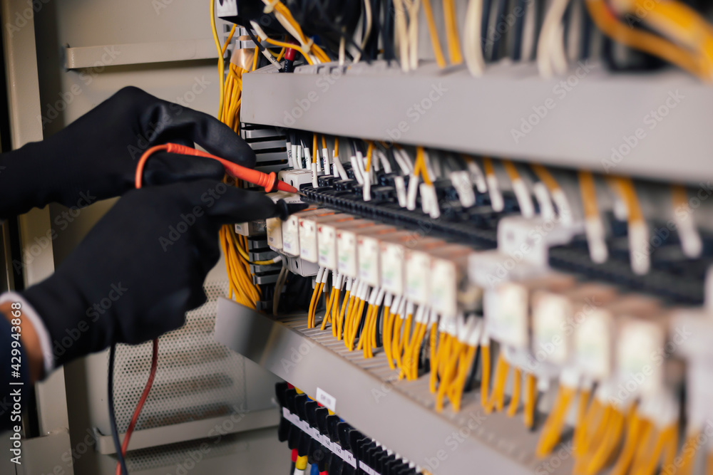 Electrician engineer work tester measuring voltage and current of power ...
