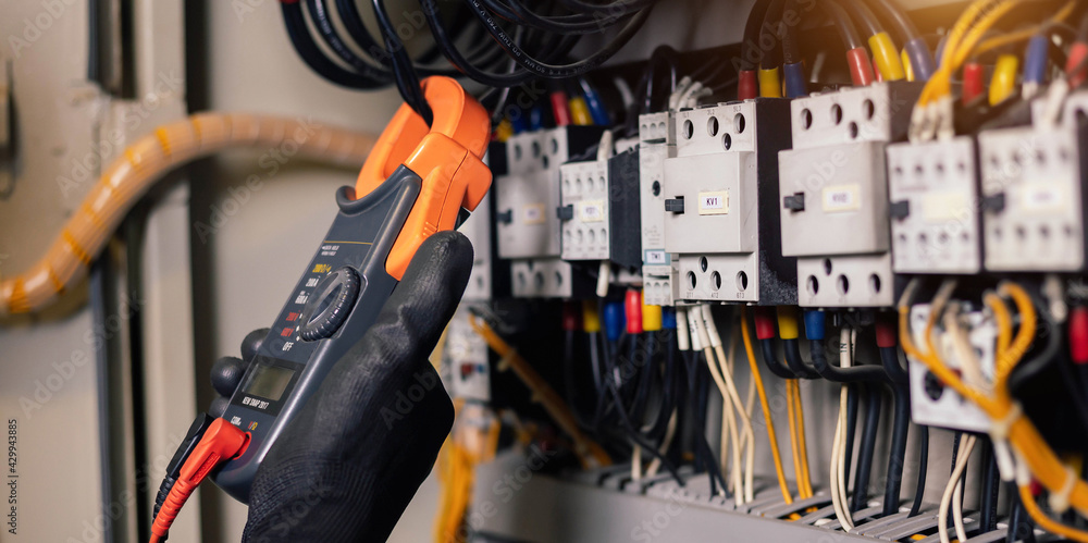 Electrician engineer work tester measuring voltage and current of power ...