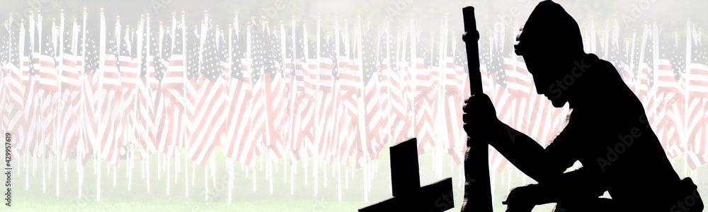 silhouette of a military person kneeling at the grave of a fallen ...