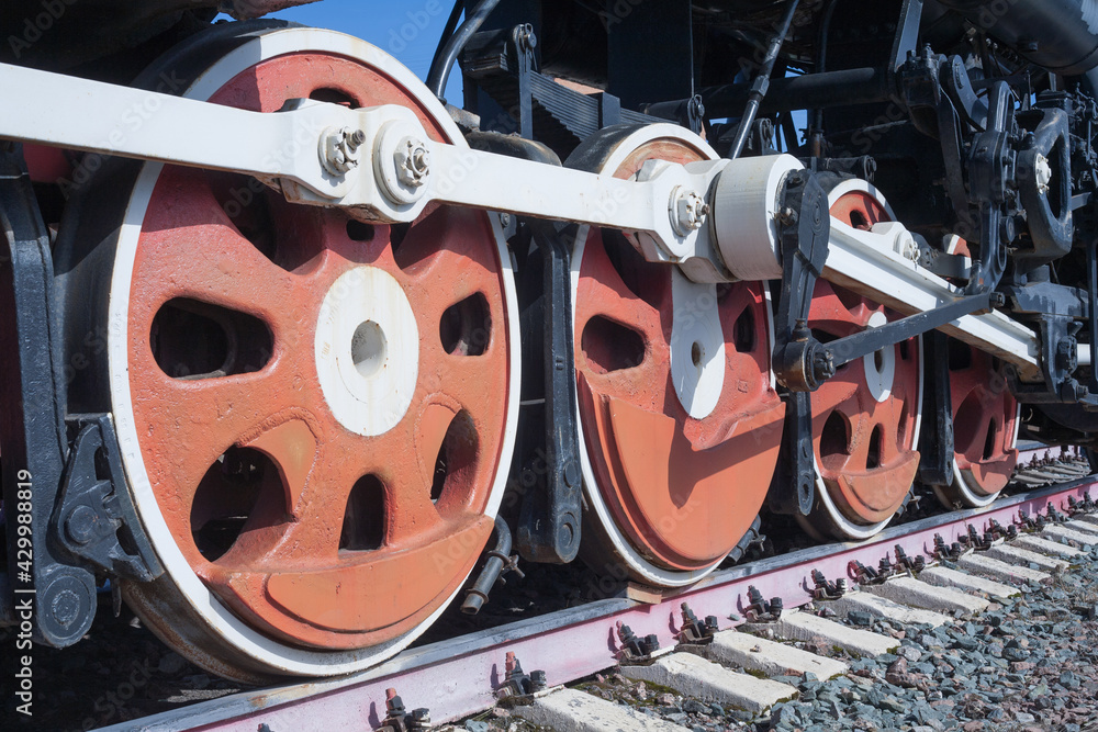 Iron wheels of mighty steam locomotives, red iron wheels of steam ...