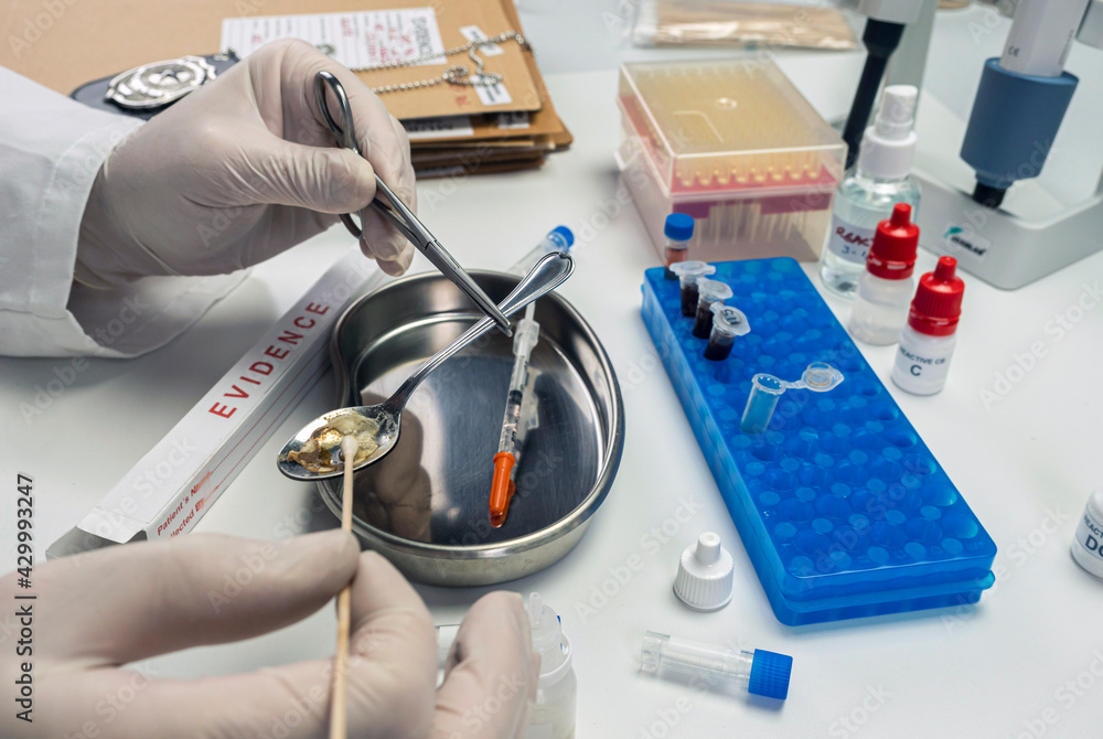 Police scientist holding spoon used in crime lab overdose case ...