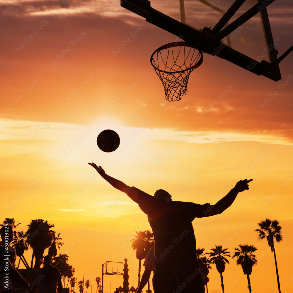 Basketball player silhouette playing at sunset in Los Angeles ...