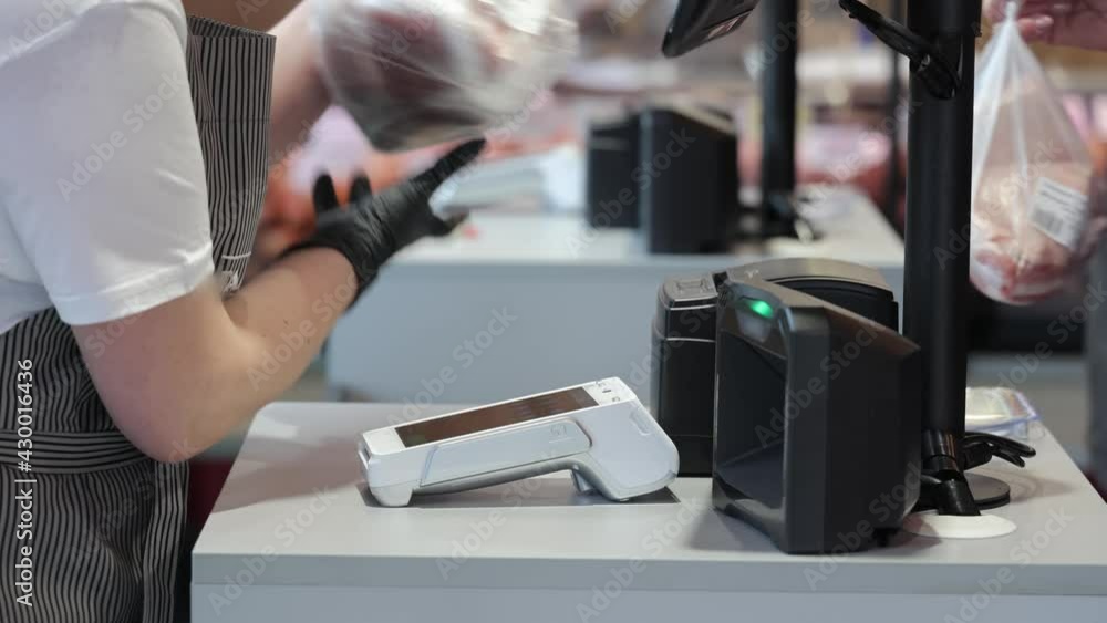 Cashier scanning goods at the supermarket checkout close up. Scanning ...