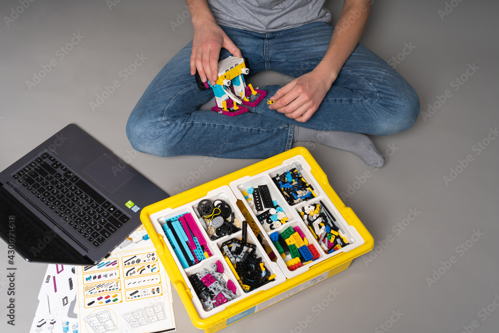 Minsk, Belarus. March, 2021. Teenagers collect and program the new Lego ...