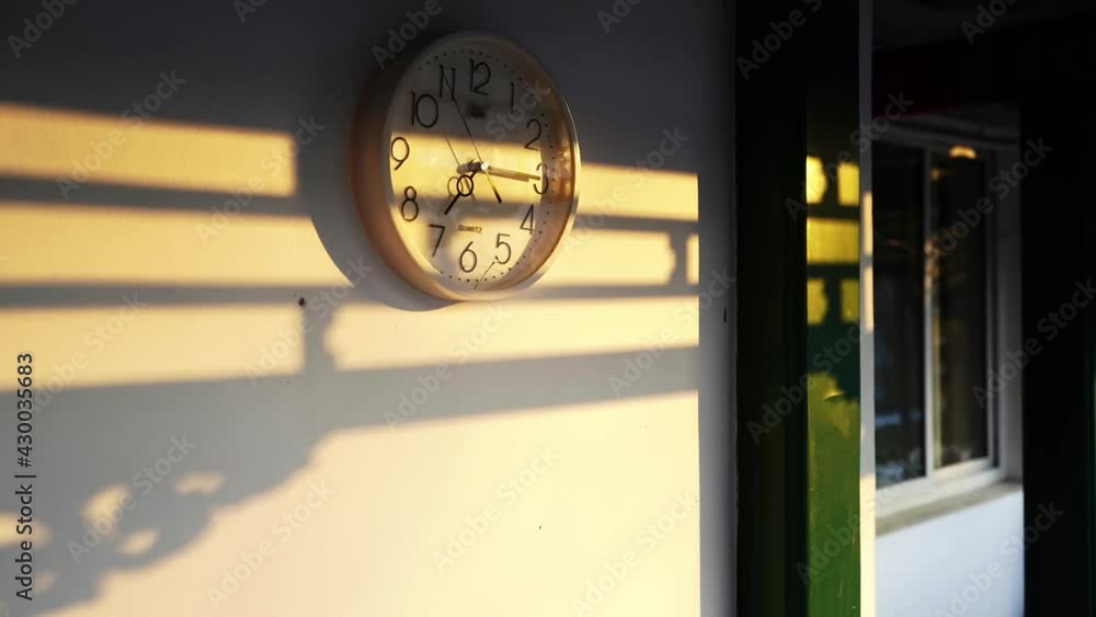 Time-lapse of a clock moving fast with shadow formed by sun shining on ...