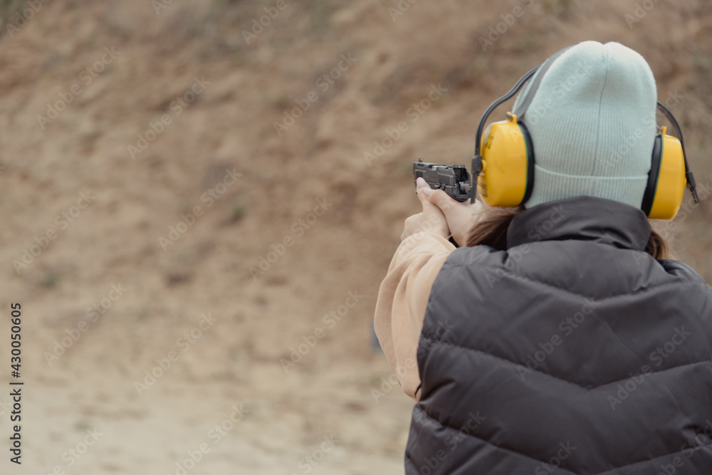 Woman fires automatic handgun pistol during training in practical ...