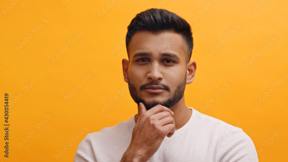 Portrait of handsome adult man touching his chin and looking up. Mixed ...