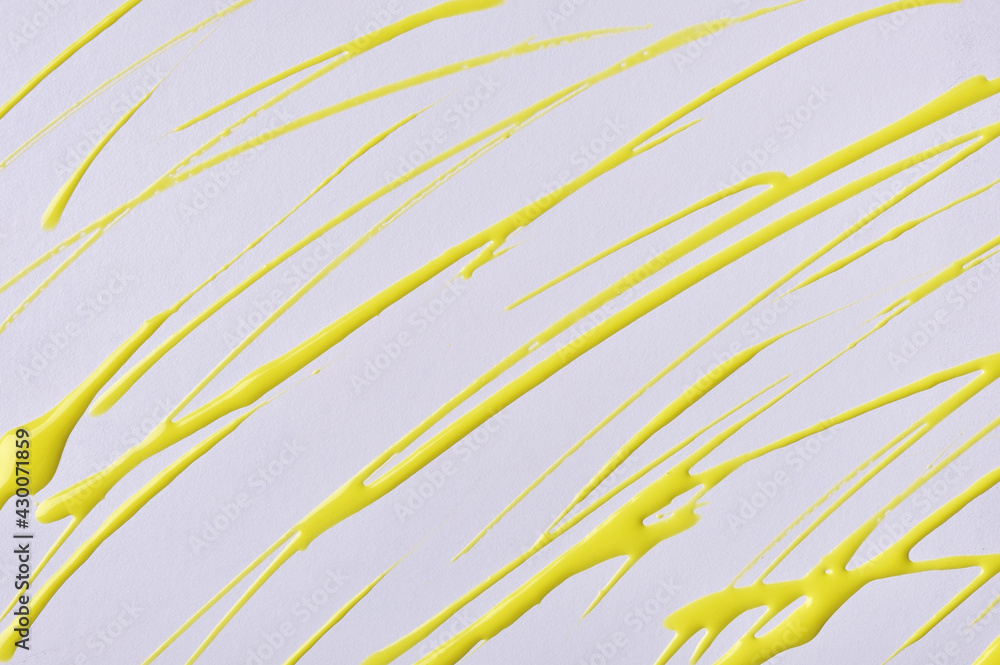 Thin light yellow lines and splashes drawn on white background ...