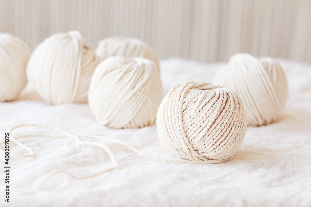 Handmade macrame braiding and cotton threads on white background. Light ...