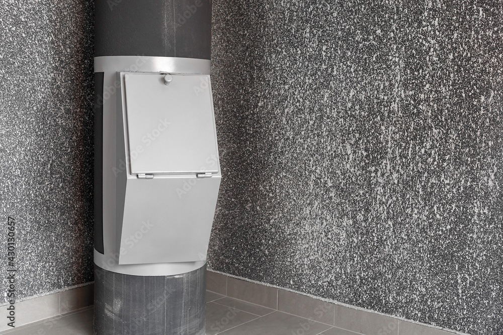 Waste disposal container installed on the floor of a multi-storey ...