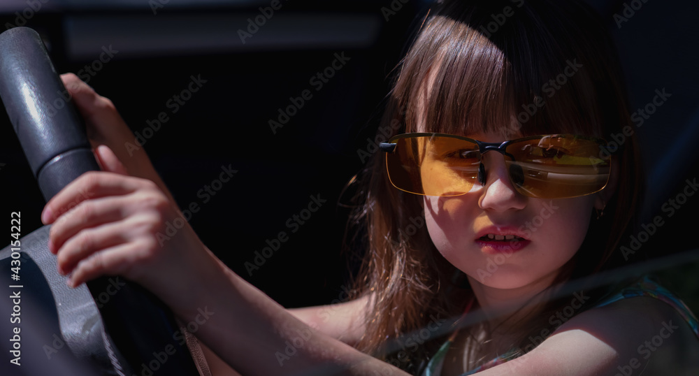 Foto de Dangers and risks of underage driving. Portrait of young child ...