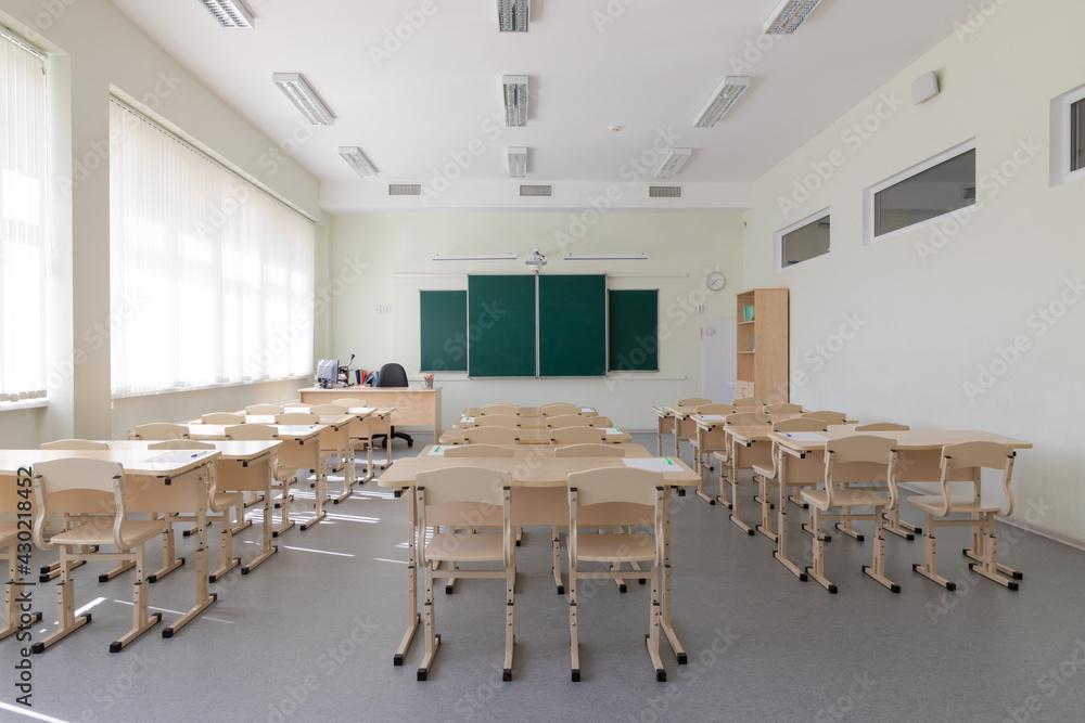 empty school class before final exams. sheets with handles are laid out ...